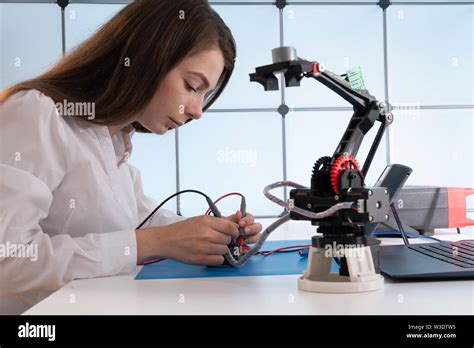 A Young Woman Writes An Algorithm For The Robot Arm Science Research