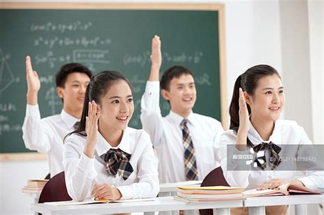 中学生在教室的课堂上举手图片素材
