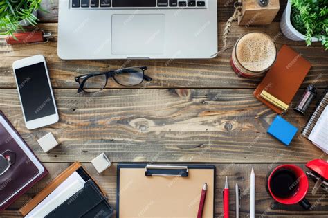 A Modern Office Desk Setup Featuring A Laptop Notebook Phone And