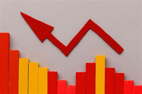 Premium Photo Paper Cutout Of A Red Arrow Pointing Upwards Over A Graph