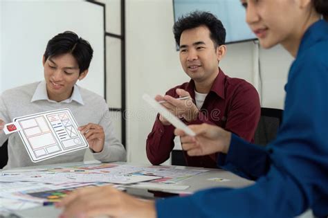 Collaboration And Ux Ui Design A Diverse Group Of Professionals Brainstorms Ux Ui Concepts In A