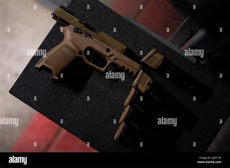A Sig Sauer P320 M18 Pistol Sits Atop A Shelf Prior To A Shooting