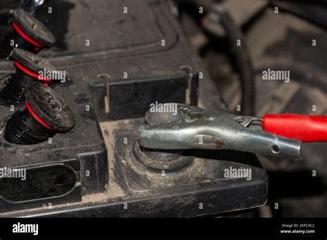 Charging A Car Battery Attached To The Battery Terminal Of The Wire From The Charger Taking