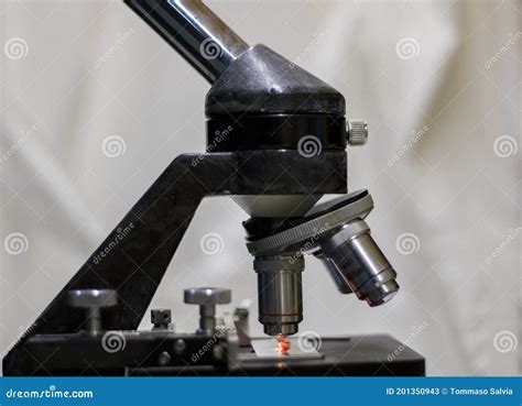 Side View Of A Microscope While Analyzing A Red Thread Stock Image