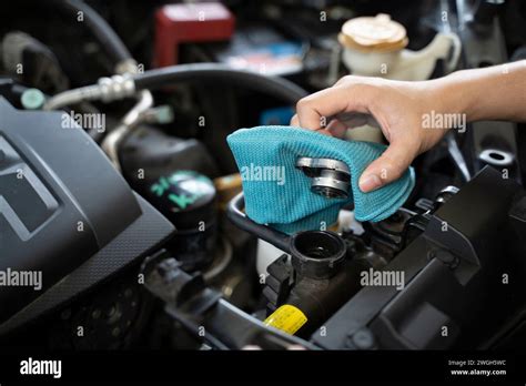 A Woman Is Checking The Engine Coolant Level Stock Photo Alamy