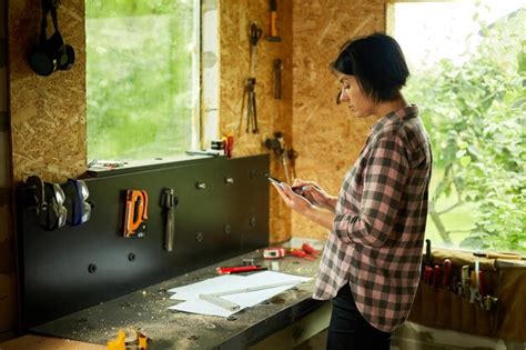 Premium Photo Female Business Owner Using Digital Tablet In Workshop