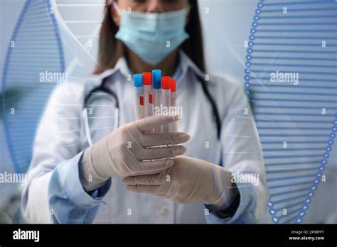 Genetic Testing Laboratory Worker With Test Tubes And Illustration Of Genetic Testing Laboratory Worker With Test Tubes And Illustration Of