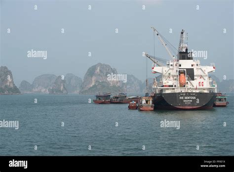 A Supply Ship From Singapore Loading Or Unloading Cargo From Communities Around Halong Bay