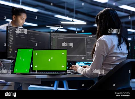 Coworkers In Data Center Using Green Screen Laptop And Tablet To Find