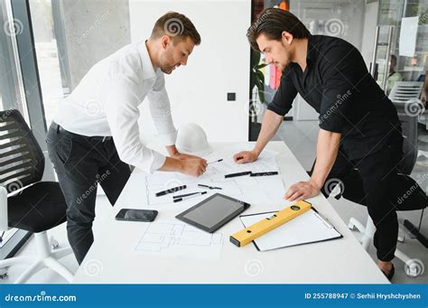 Engineers Are Helping To Design Work On Blueprints And Collaborate On Structural Analyzing Of