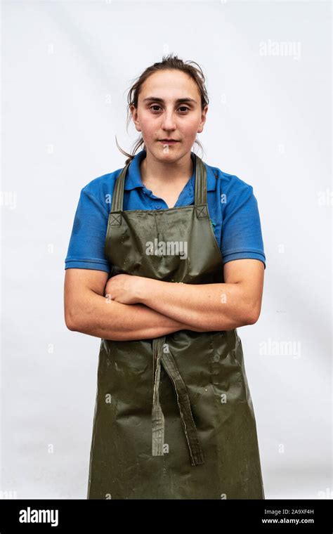 Portrait Of Female Farmer Wearing Green Apron Looking At Camera Stock