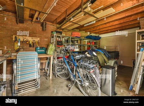 a garage with many bikes parked in the garage, and one bike is leaning up against the wall on ...
