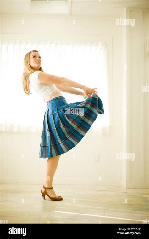 Woman Playfully Lifting Her Skirt Stock Photo Alamy