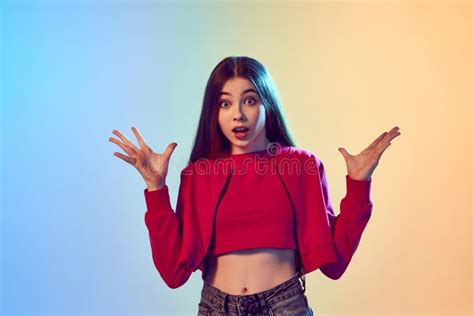 Surprised Beautiful Girl With Open Mouth And Spreading Hands To Side
