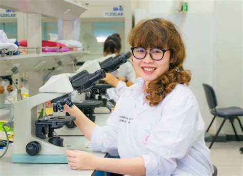 Female Scientist Looking In Microscope In Laboratory Laboratory Stock