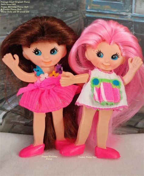 Two Dolls Are Standing Next To Each Other