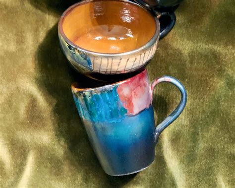 Black Art Mug With Multi Colored Rim And Metallic Highlights