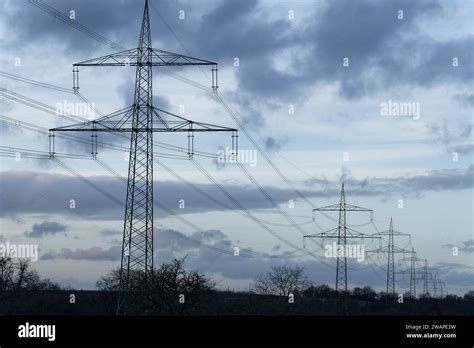 High Voltage Pylons Arranged In A Row Extending To The Rear With An