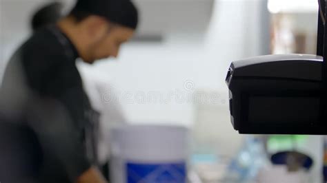 Kitchen Ticket Printer With Hispanic Chefs As Background Stock Video