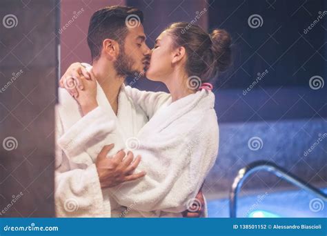Passionate Young Couple Kissing During A Swimming Pool Spa Center Day