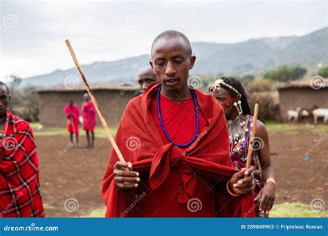 Masai In Traditional Colorful Clothing Showing Maasai Jumping Dance At