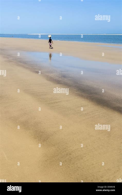 Malagasy Woman Walking On The Beach Of Morondava Western Madagascar On