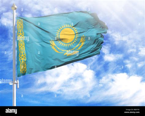 National Flag Of Kazakhstan On A Flagpole In Front Of Blue Sky Stock