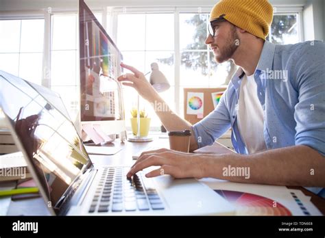 Young Creative Manager Sitting At His Table And Working On Computer He