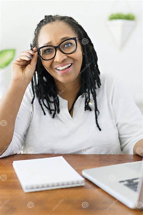 black woman using computer in modern kitchen interior stock image