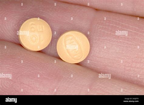 Morphine Two 10mg Tablets Of Slow Release Morphine Sulphate Mst Held In The Palm Of A Hand