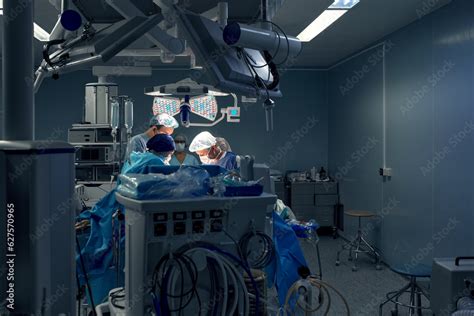 Surgeons Team During Complex Surgical Operation In A Sterile Operating Room Doctors Leaned Over