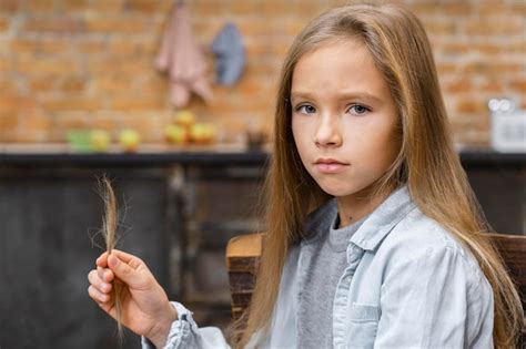 Маленькая девочка выпрямляет волосы парикмахером | Бесплатно Фото