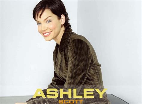 Download Ashley Scott Striking A Pose In Front Of The Camera Wallpaper