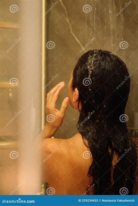 Back View Of Beautiful Naked Young Woman Taking Shower In Bathroom