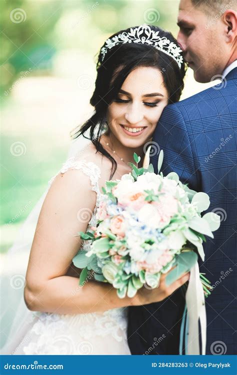 Romantic Fairytale Happy Newlywed Couple Hugging And Kissing In A