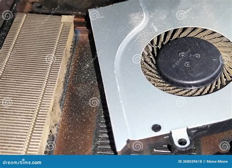 Dismantled Parts Of An Old Laptop Cooling Systems Like A Fan And A Radiator Which Are Clogged