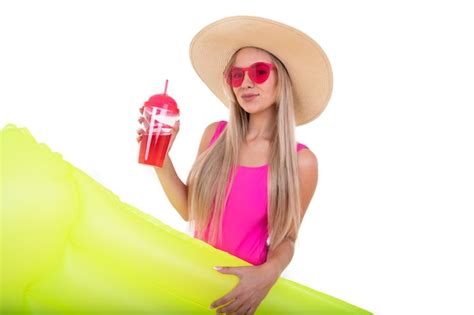 Premium Photo Woman In A Pink Bathing Suit And Hat Holds An Air