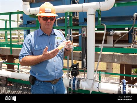 White Male Worker Holds Up A Sample Of Processed Uranium At An Uranium