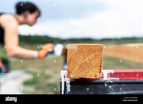 The Woman Impregnates Raw Planed Wooden Pine Beams With Dimensions Of 100x100mm With A Colorless
