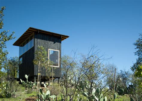 Charred Cabin By Draa Is A Blackened Timber Shelter On Stilts