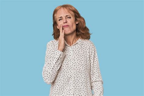 Premium Photo Redhead Midaged Caucasian Woman In Studio Having A Strong Teeth Pain Molar Ache