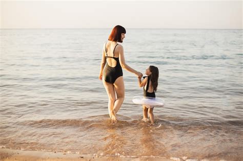 Premium Photo Happy Mother With Red Hair And Young Daughter In Black