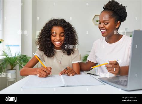 Caring And Friendly Mother Helps Her Daughter To Do Homework That Was