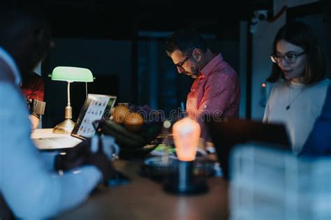 Multiracial Business Team Collaborating On Project Details Analyzing Statistics Making Sales