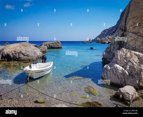 Boat In Calm Bay On Hot Summer Day With Beautiful Blue Sky And Water