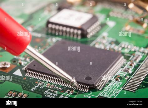 Measuring Micro Chip With Red Probe On Green Circuit Board Stock Photo Alamy