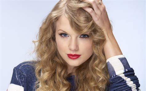 Taylor Swift Wearing Blue And White Long Sleeved Shirt Taking Picture
