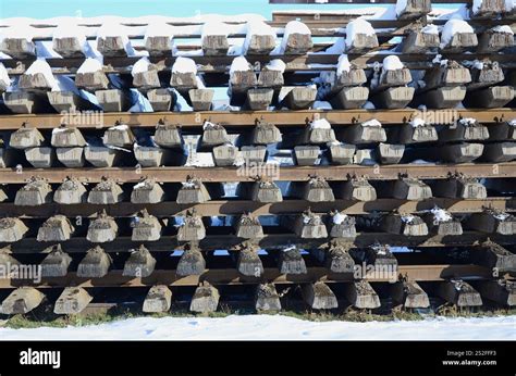 A Lot Of Old Rails And Sleepers Are Stacked In A Railway Warehouse In