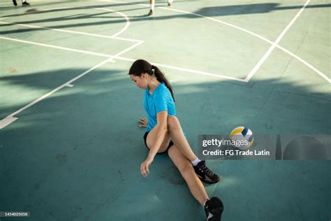 Female Volleyball Player Stretching At The Volleyball Court High Res