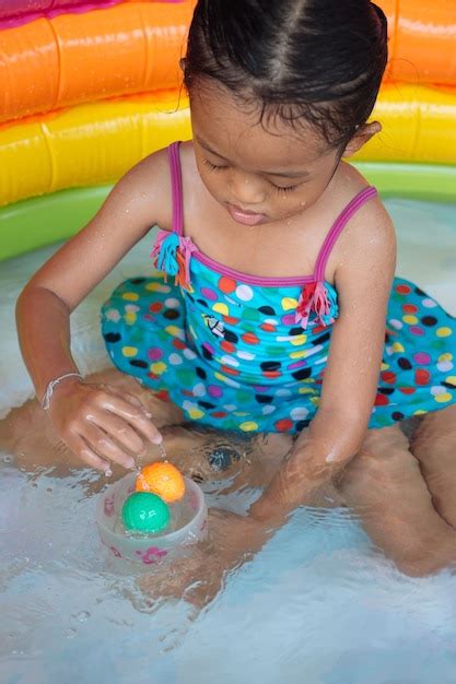 Premium Photo Girl Playing In Wading Pool